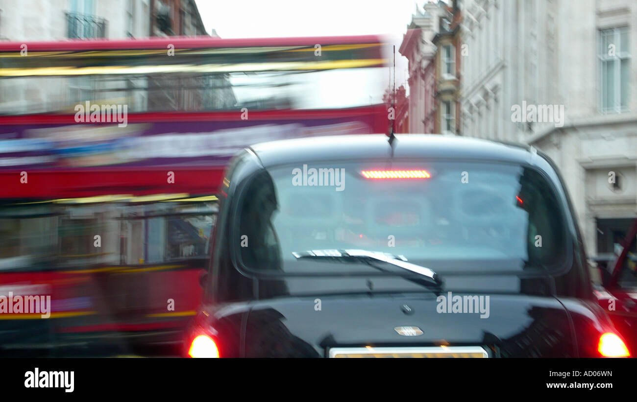 Taxi cab and blurring double decker bus, London UK Stock Photo - Alamy