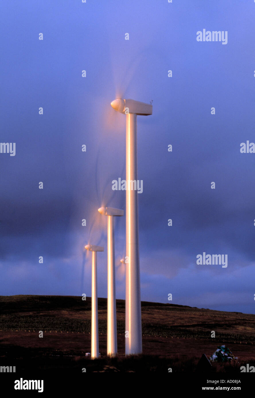 three 3 wind generating windmills/ turbines in rotation/motion, wind ...