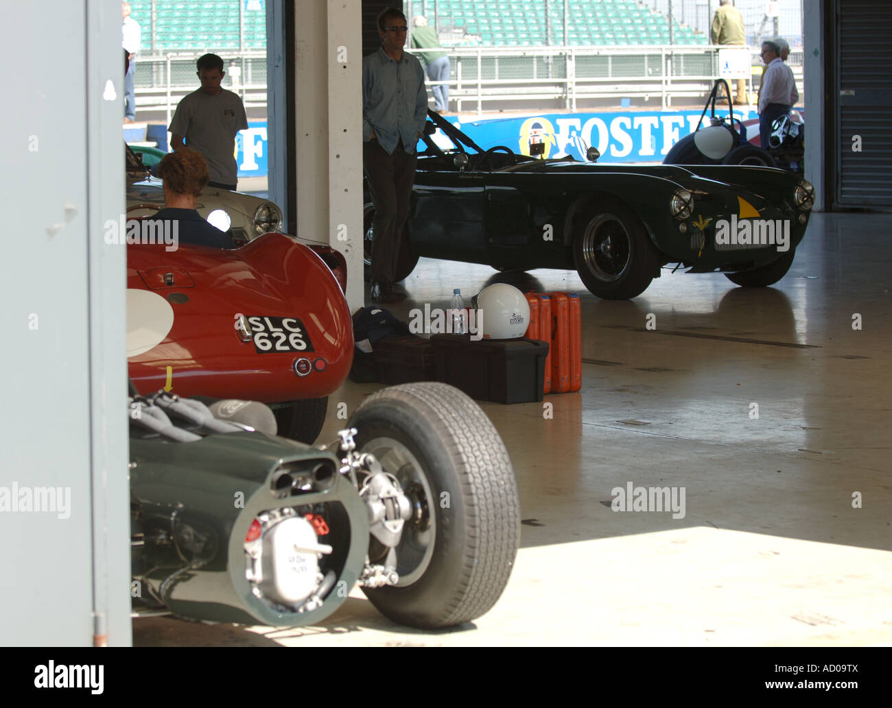 Historic racing cars in a pit lane garage at Silverstone prepare to go ...