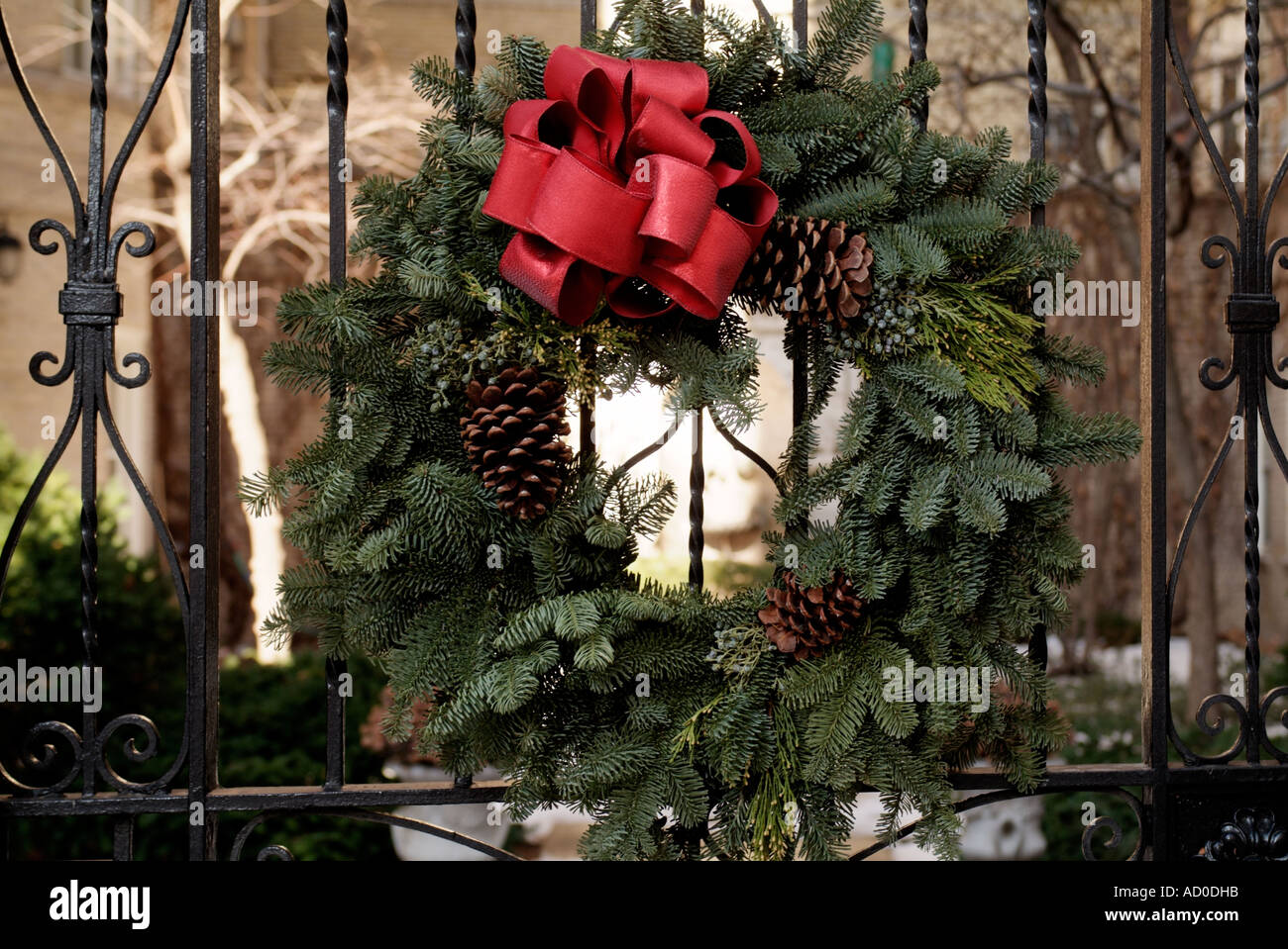 Christmas Wreath with Red Ribbon and Pine Cones on Building Gate Stock ...