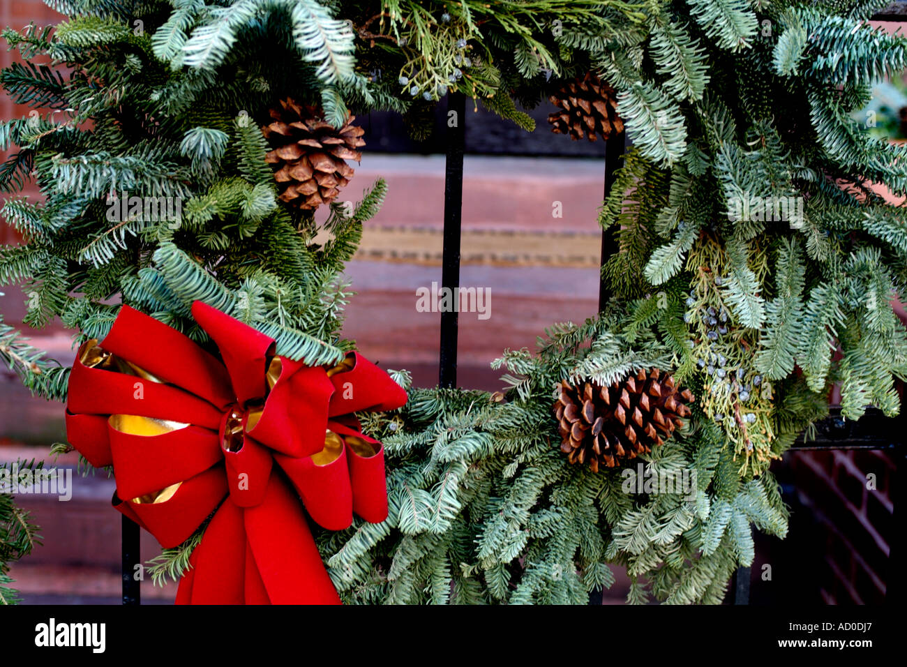 Christmas Wreath with Red Ribbon and Pine Cones on Building Gate Stock ...