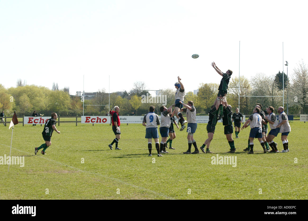 local rugby game in local park in spring sunshine with action at a line ...