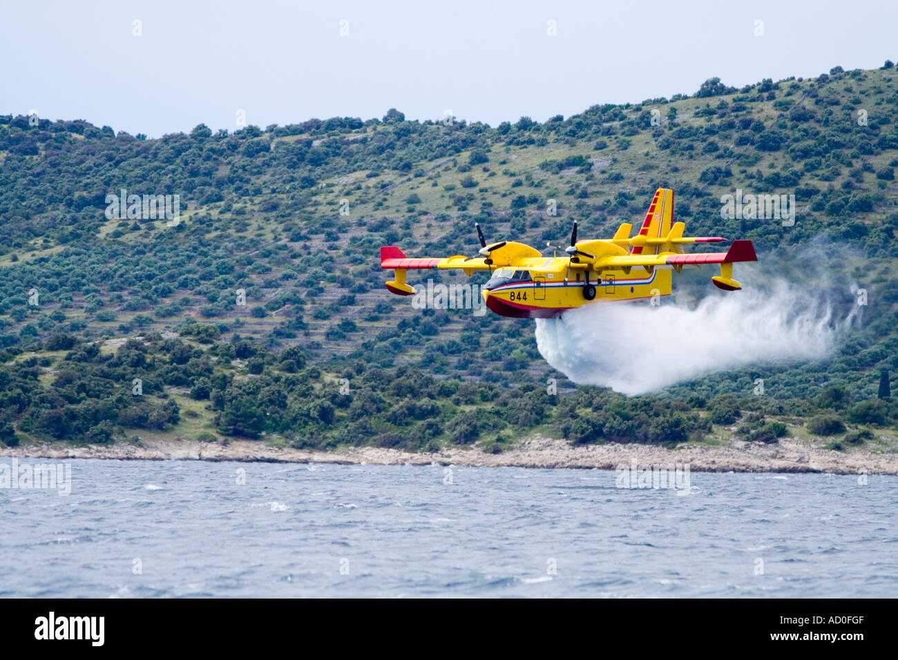 Firefighting plane releasing water Stock Photo - Alamy