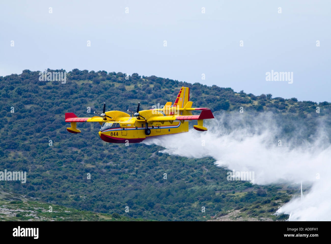 Firefighting plane releasing water Stock Photo - Alamy