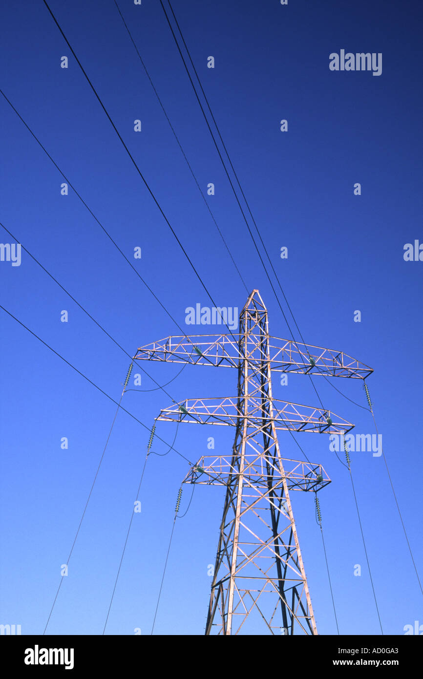 High voltage pylons and electrical cables against a blue sky Stock ...