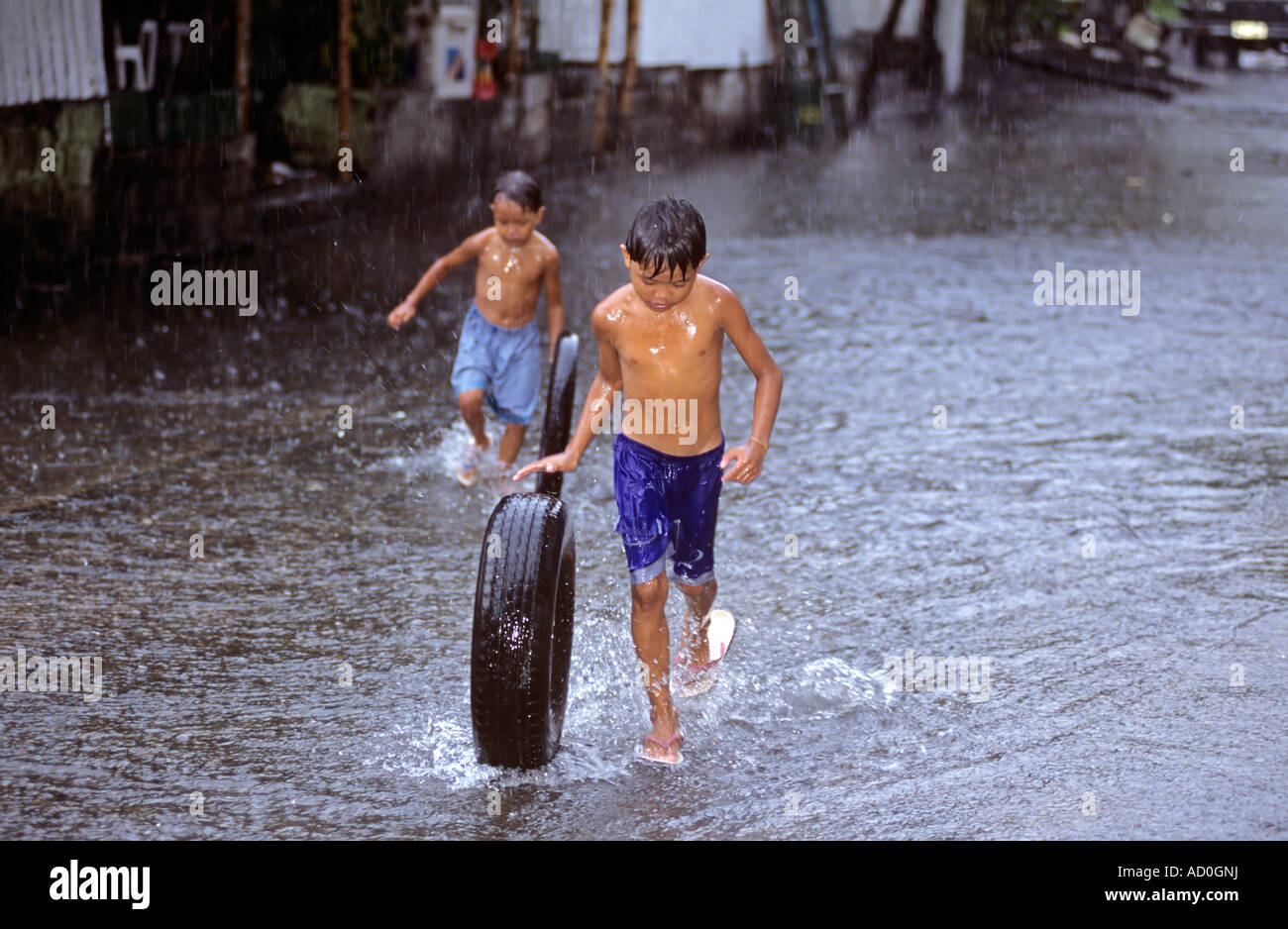 Kids playing in the rain Makati Manila Philippines Stock Photo - Alamy