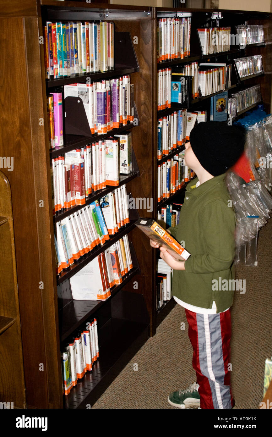 Boy age 7 selecting videos to borrow. James J. Hill Reference Library ...