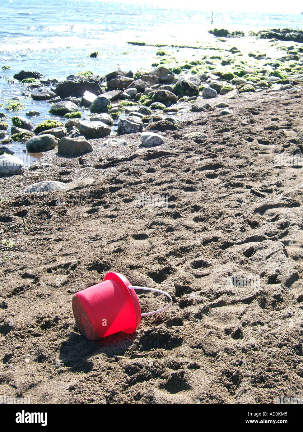 red bucket left on beach Stock Photo - Alamy