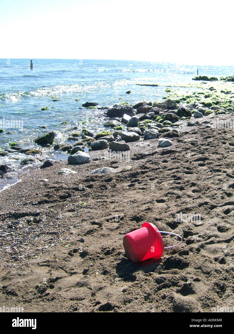 red bucket left on beach Stock Photo - Alamy