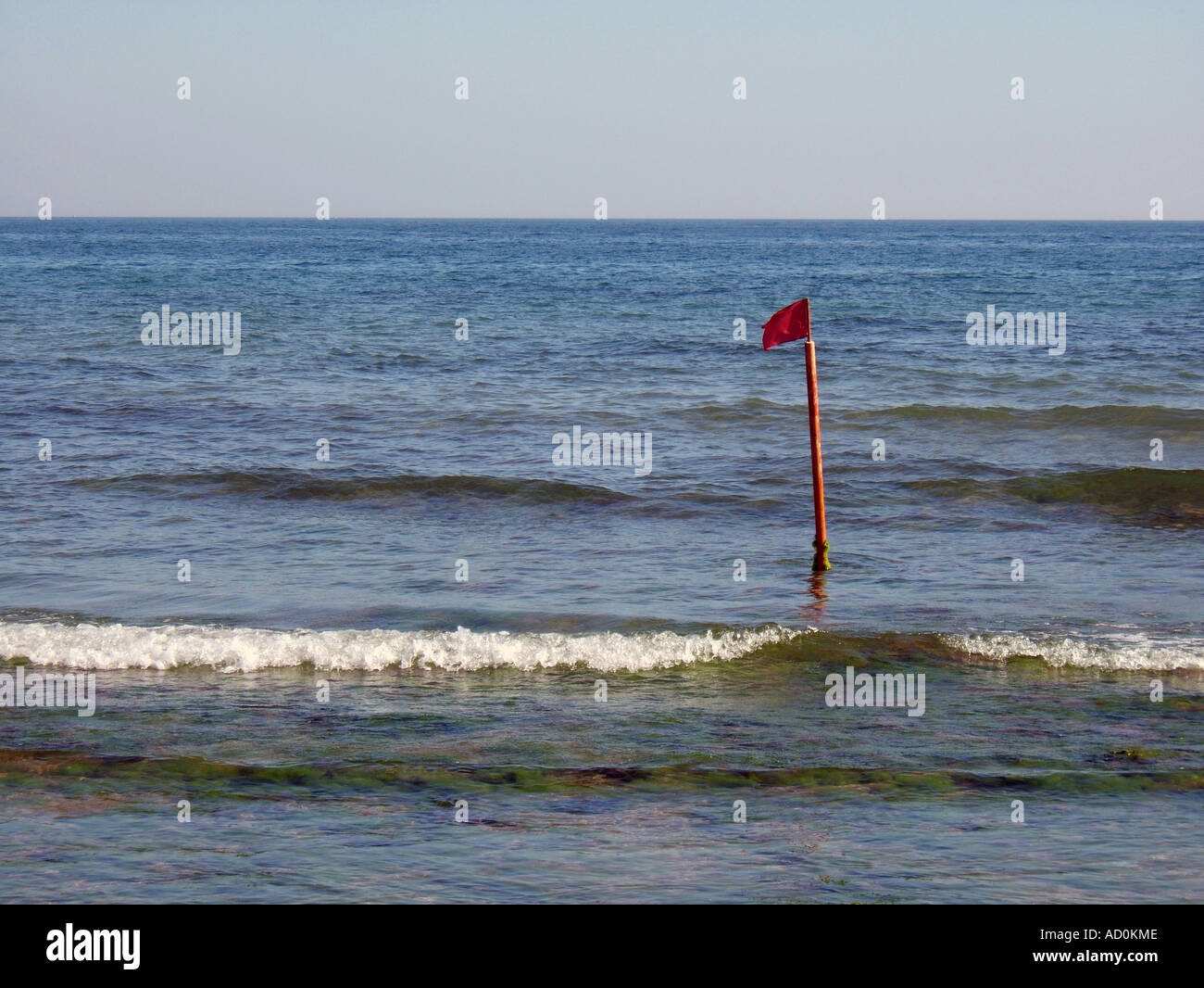 red warning flag in sea Stock Photo - Alamy