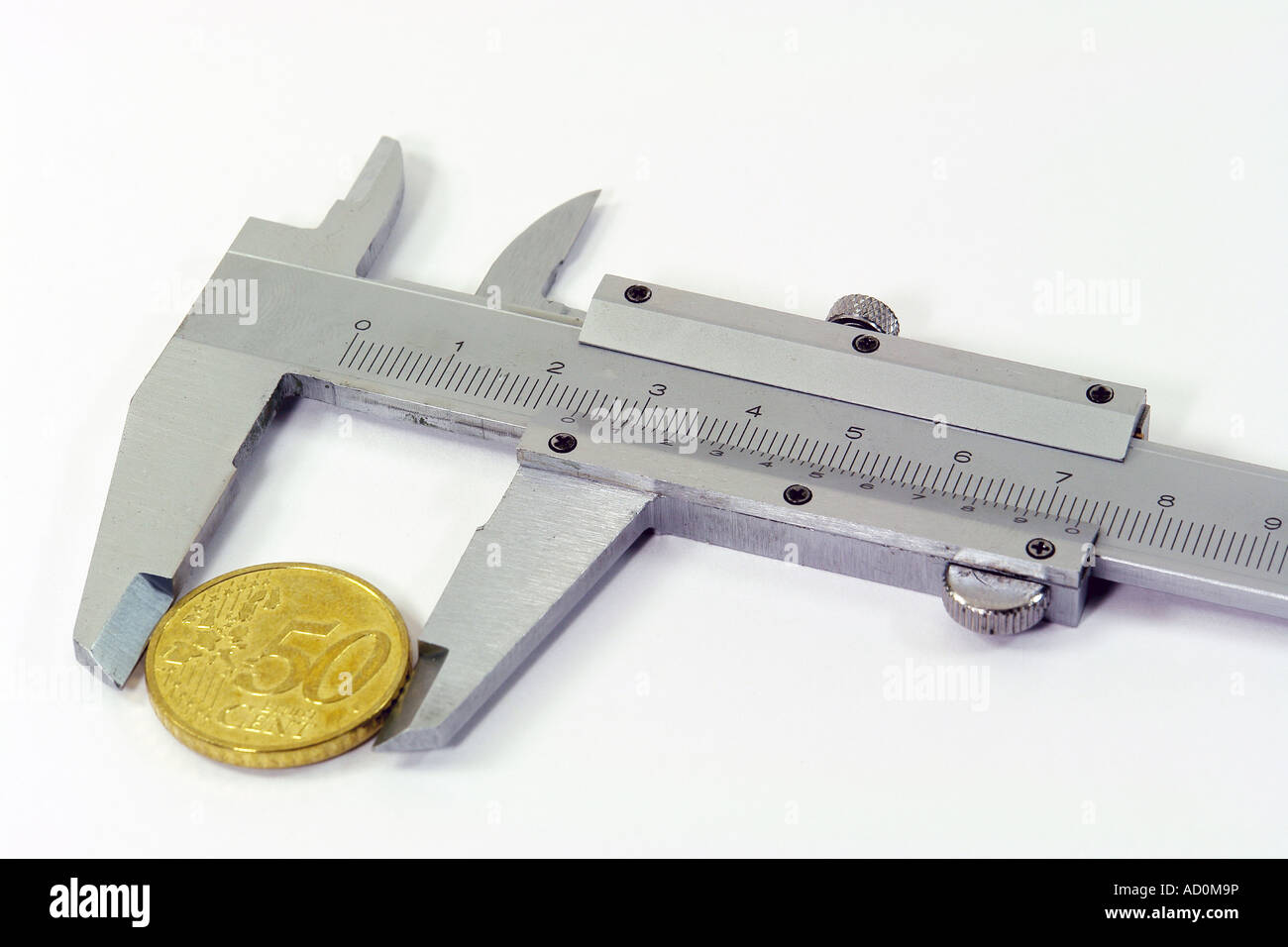 Caliper gauge with a euro coin as symbol for the measurement of the ...