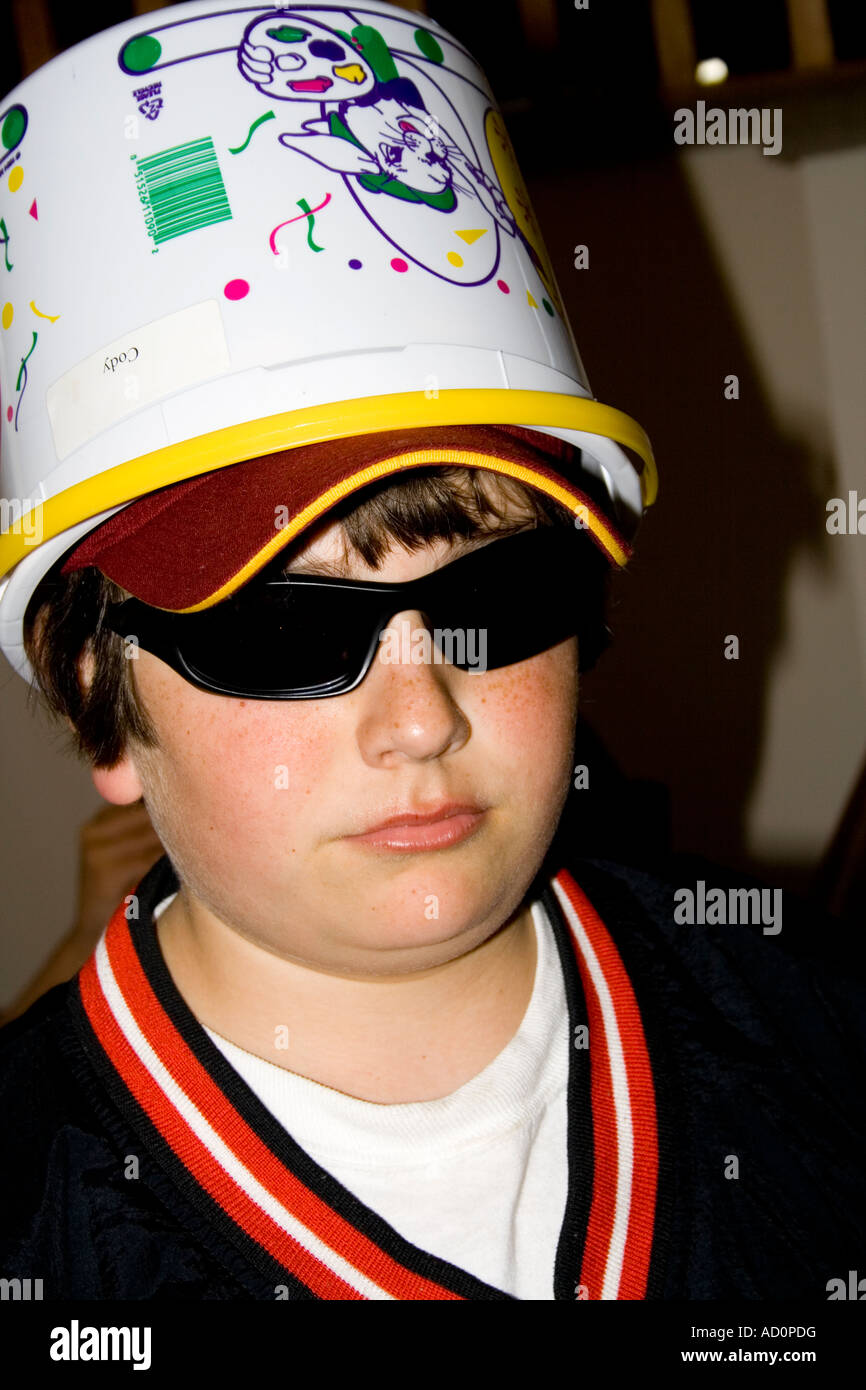 Boy age 12 prepared for Easter egg hunt with basket on head. Mahtomedi ...