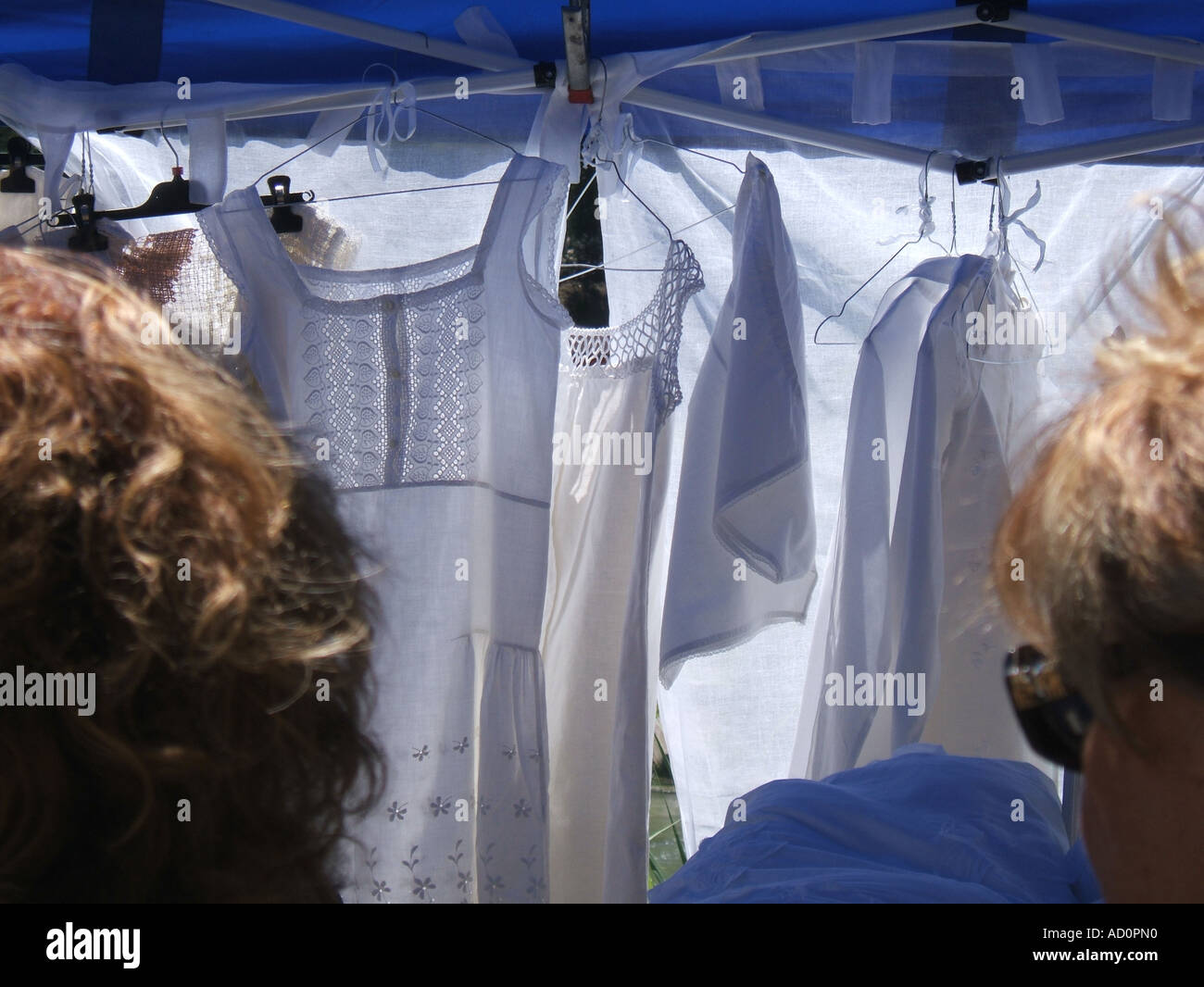 white dresses on market stall Stock Photo - Alamy