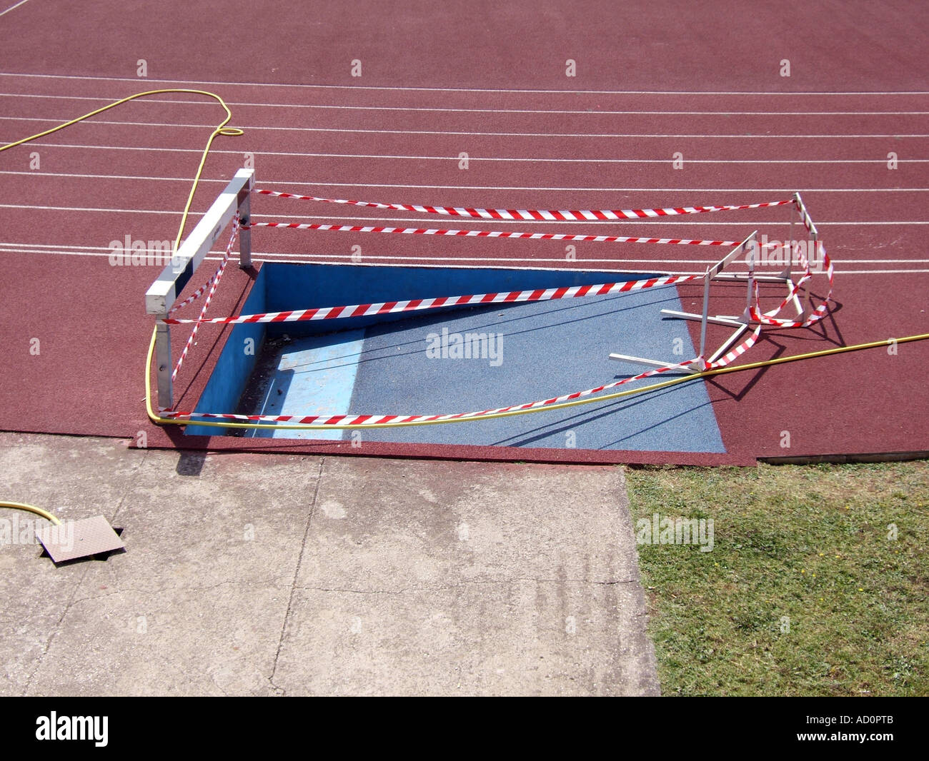 steeplechase hurdle water pit blocked with red and white tape Stock Photo - Alamy