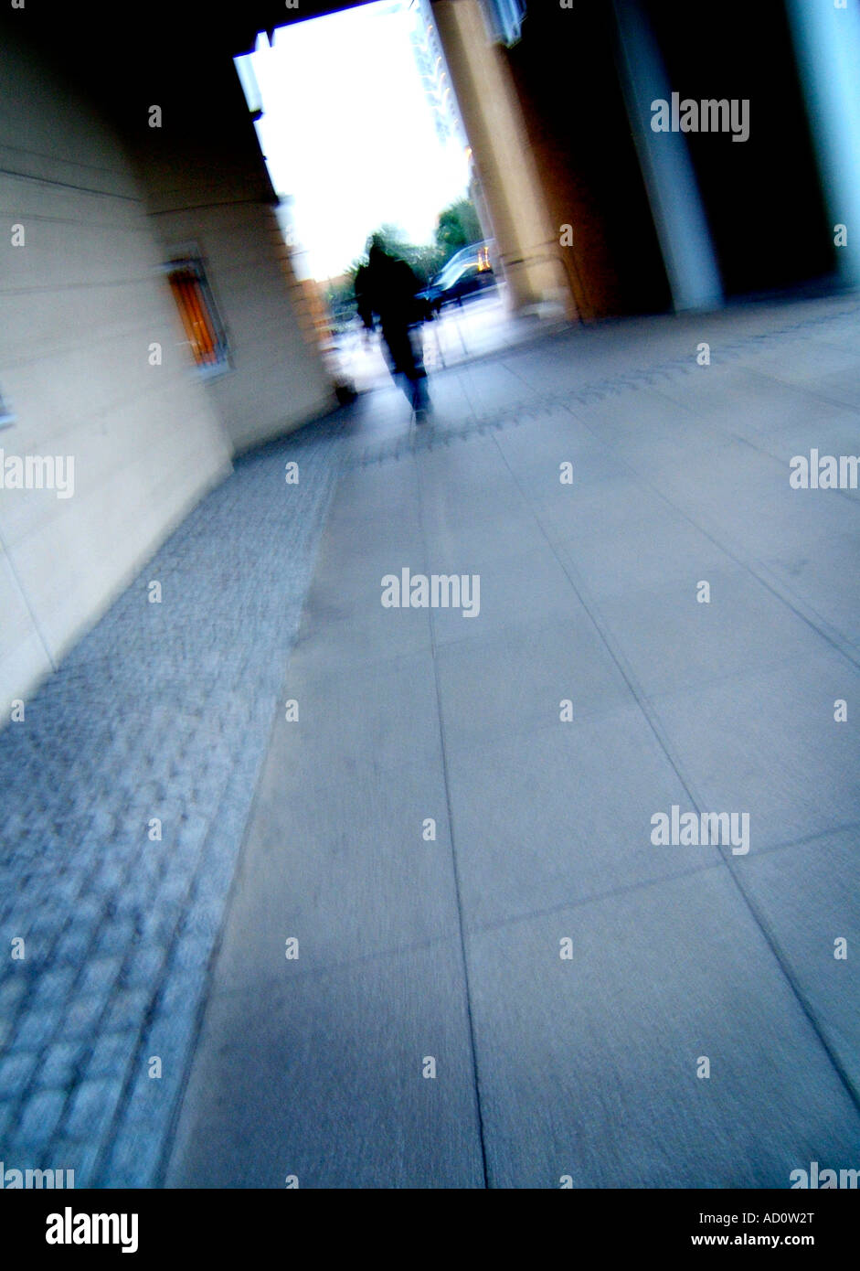 solitary blurry figure walking Stock Photo - Alamy