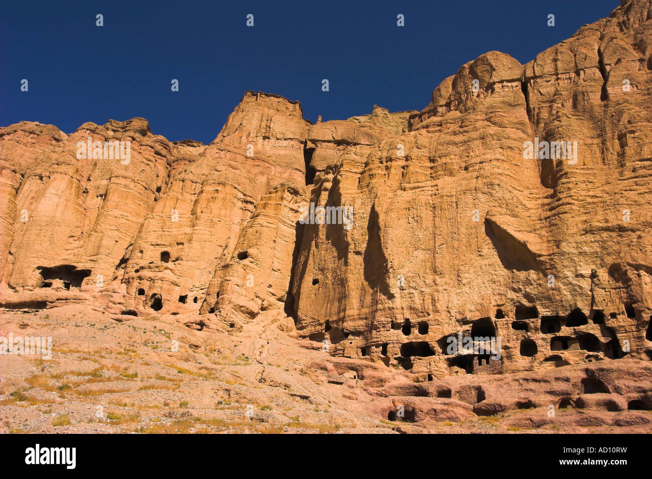 Afghanistan, Bamiyan Province, Caves in cliffs near empty niche where ...