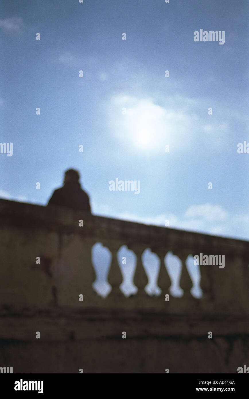 one single person standing by wall Stock Photo - Alamy