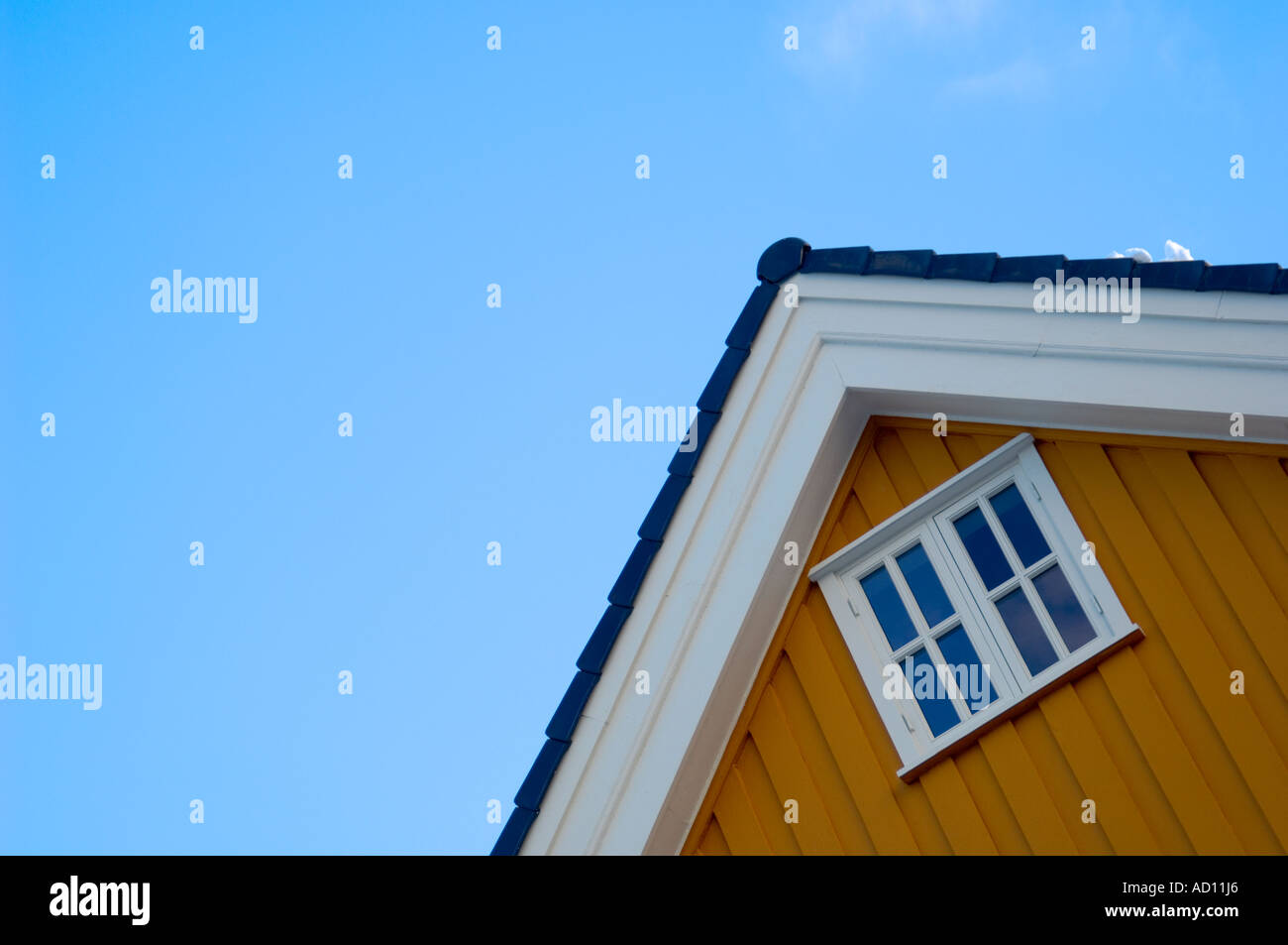 Small-paned window of yellow clap board house at the Norsk Folkesmuseum ...