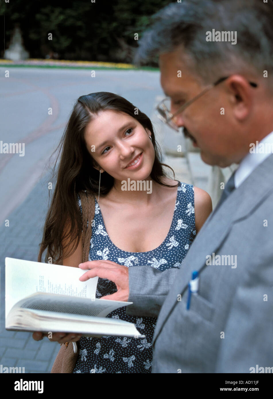 teacher examining student Stock Photo - Alamy