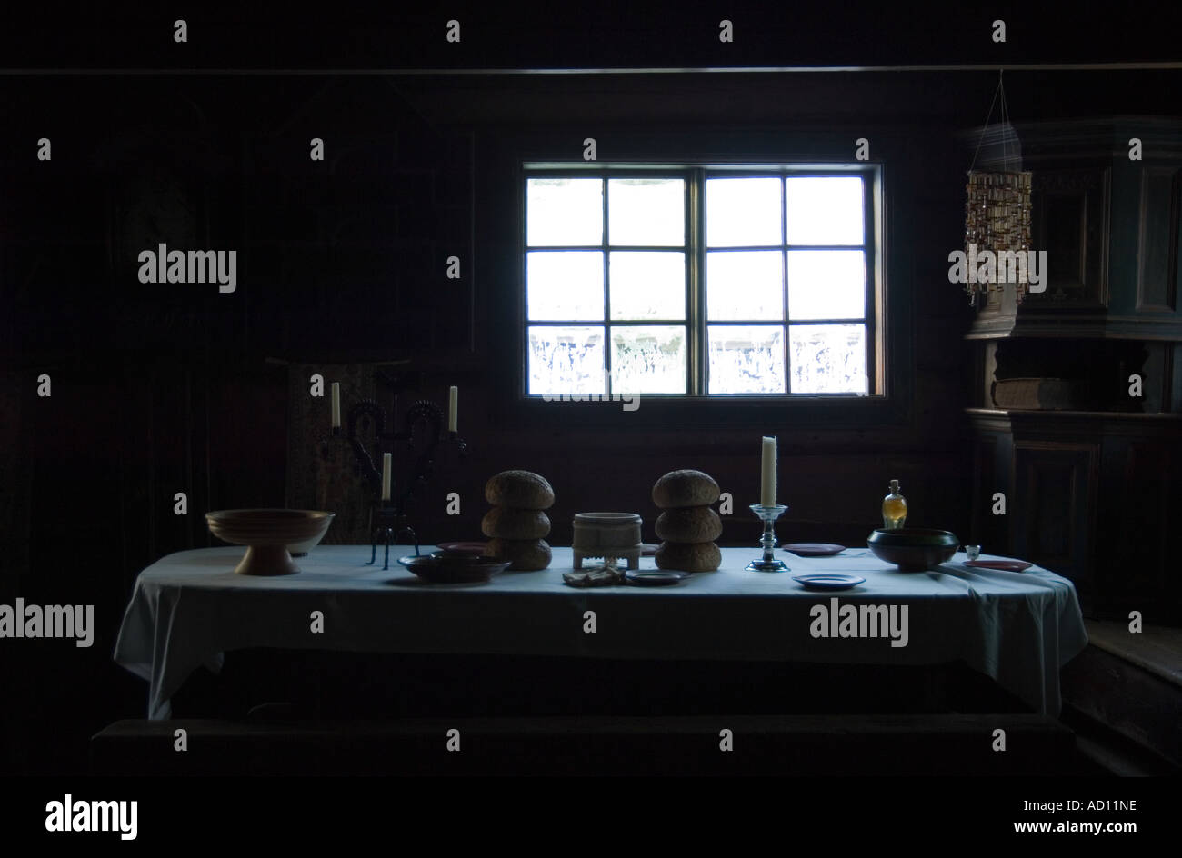 Interior of wooden house, with small-paned stained glass windows at the ...