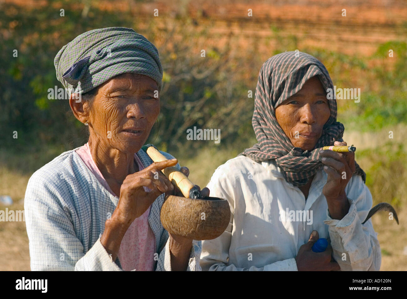Burmese women smoking big corn cigar among, Bagan, Myanmar (Burma Stock ...