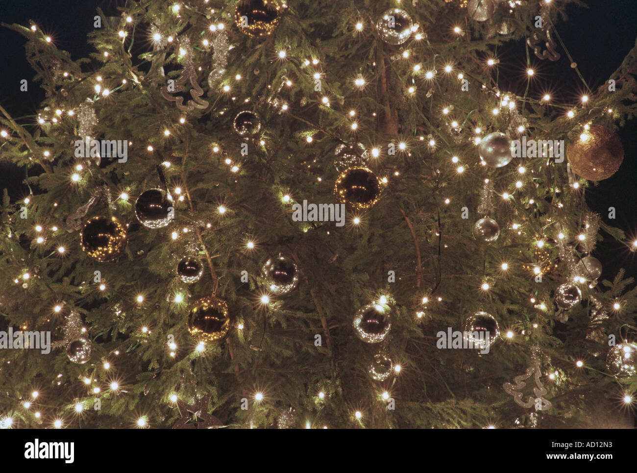 christmas tree with colourful lights at night Stock Photo - Alamy