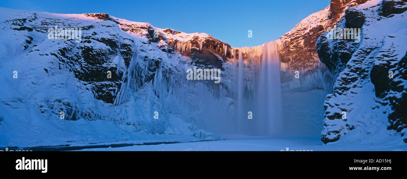 Iceland, Skogar, Skogafoss, Skogafoss waterfall surrounded by snow and ...