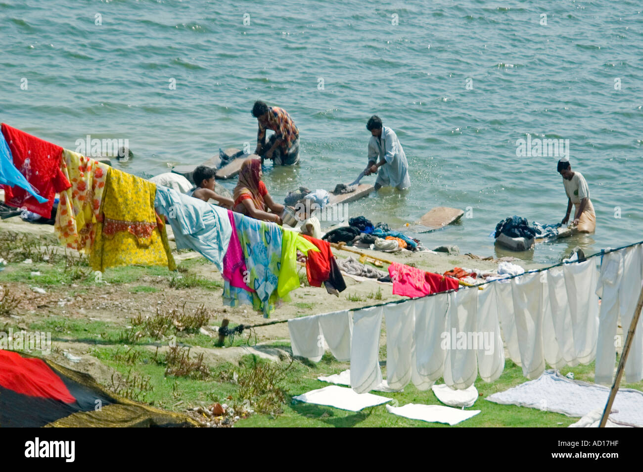 Horizontal portrait of Indian 'dhobi wallahs' washing laundry close to ...