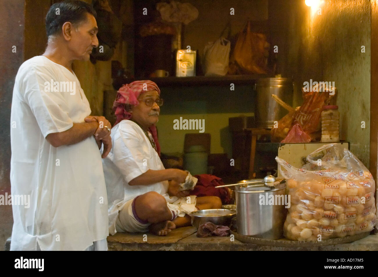 Horizontal portrait of a Indian fast food chef serving a customer with ...