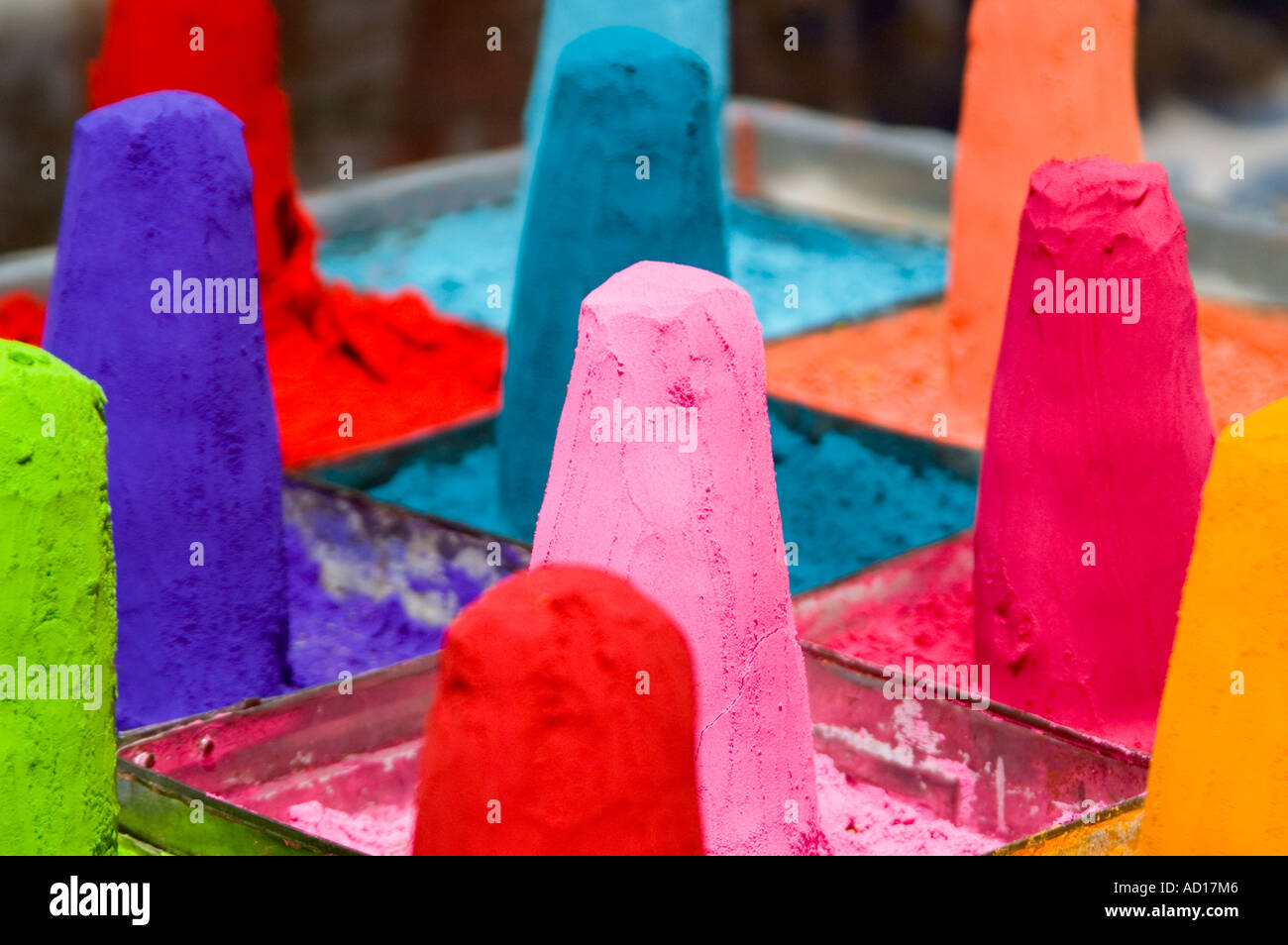 Horizontal close up of mounds of brightly coloured powder 'gulal' for ...