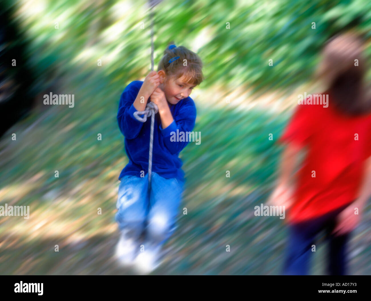 Girls playing swinging swing rope hi-res stock photography and images ...