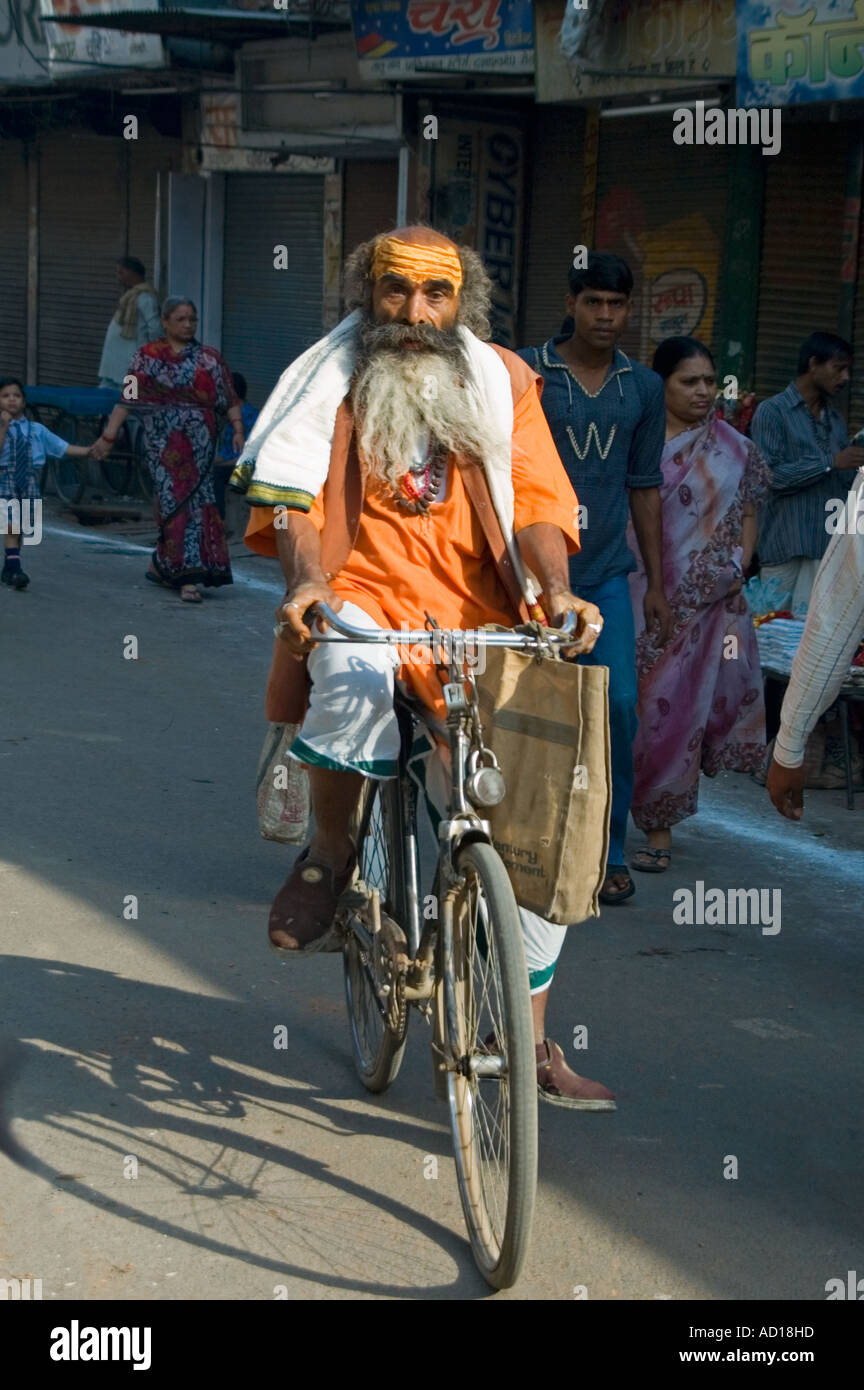 Vertical portrait of an Indian Sadhu 'holy man' cycling through the ...