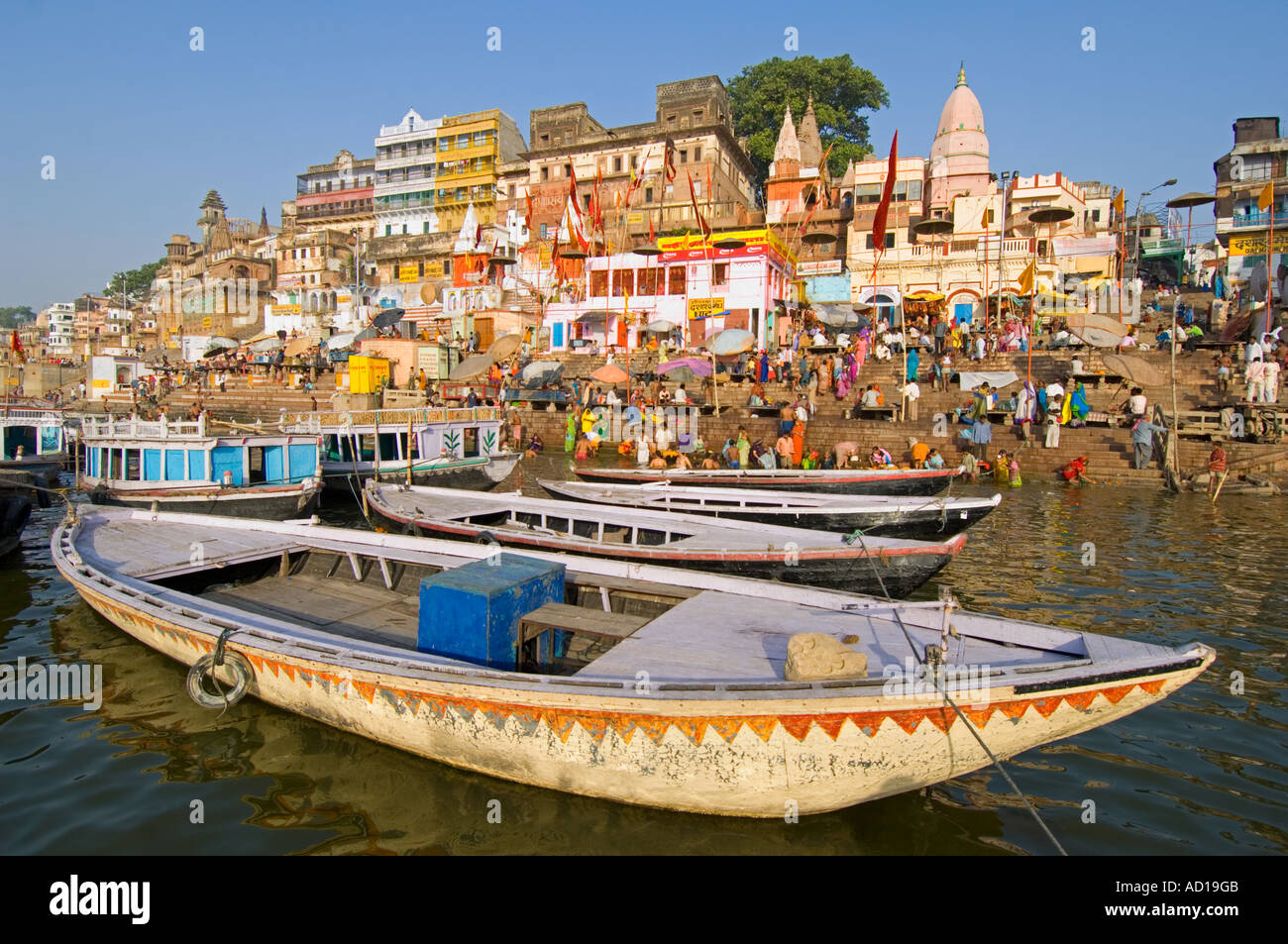 People perform their daily bathing and prayer rituals around ...