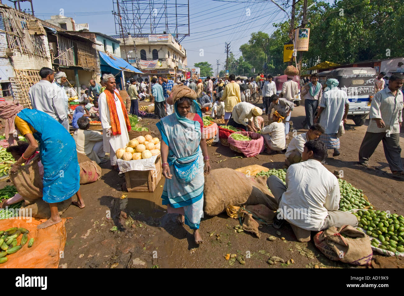 Typical street scene in Varanasi with locals shopping in a make shift ...