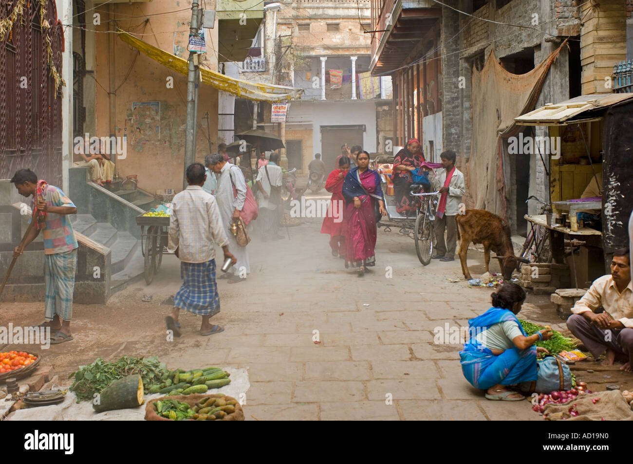 A typical street scene in the narrow backstreets of old Varanasi with ...