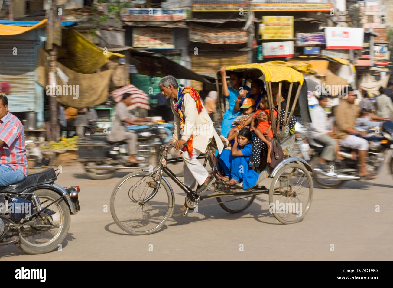 An Indian family on a cycle rickshaw in Varanasi. Slow shutter speed ...