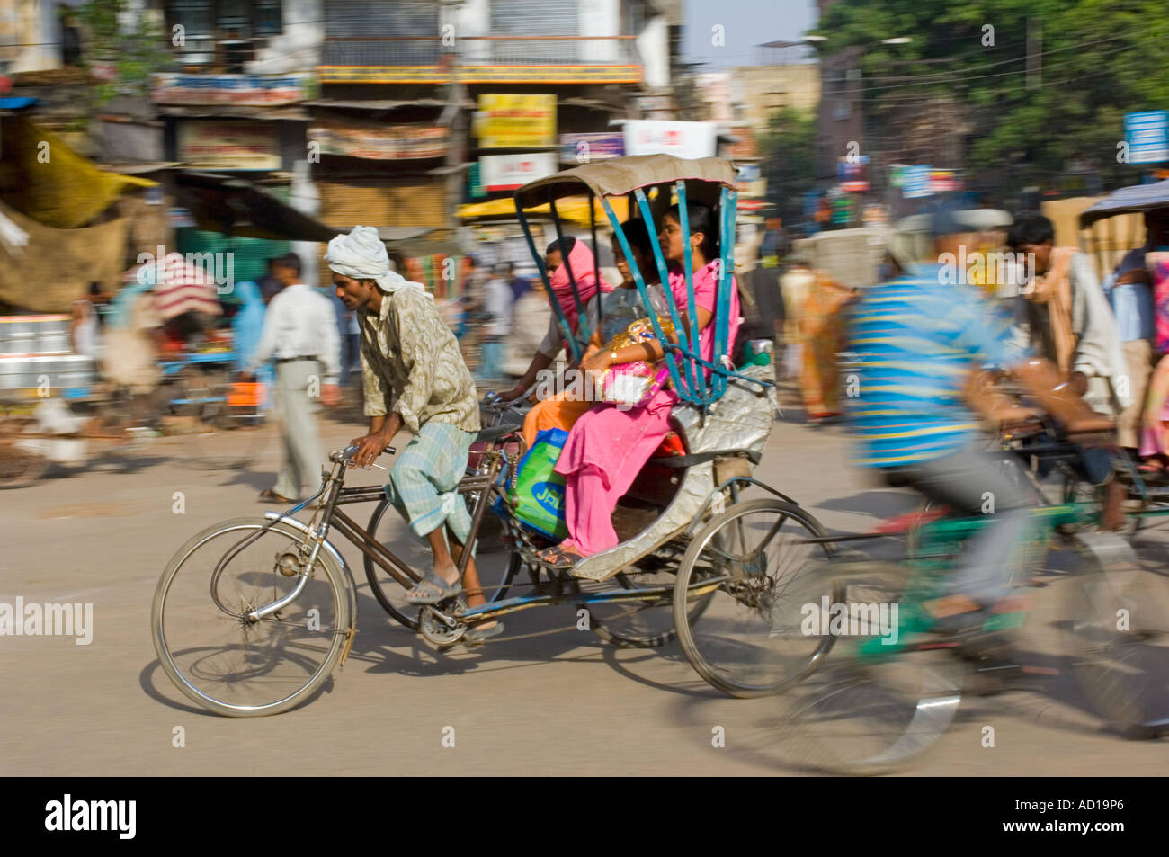 An Indian family on a cycle rickshaw in Varanasi. Slow shutter speed ...