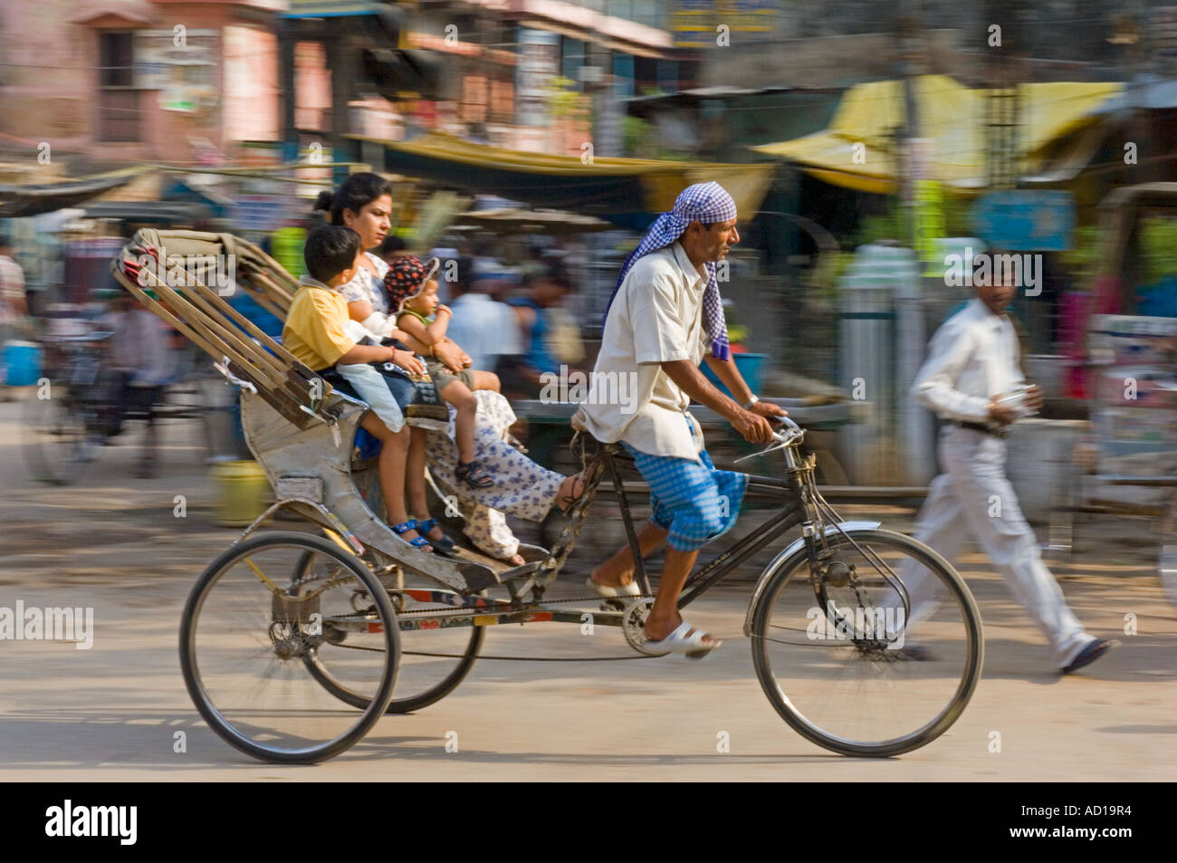 An Indian family on a cycle rickshaw in Varanasi. Slow shutter speed ...