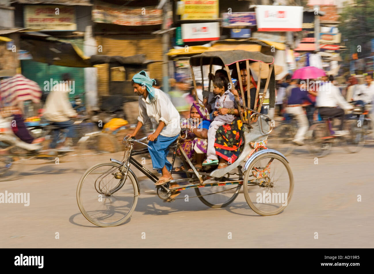 An Indian family on a cycle rickshaw in Varanasi. Slow shutter speed ...