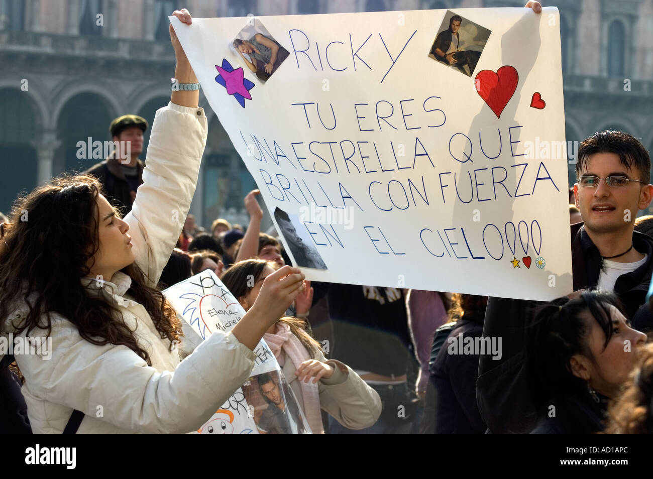 couple with a banner talking about ricky martin Stock Photo - Alamy