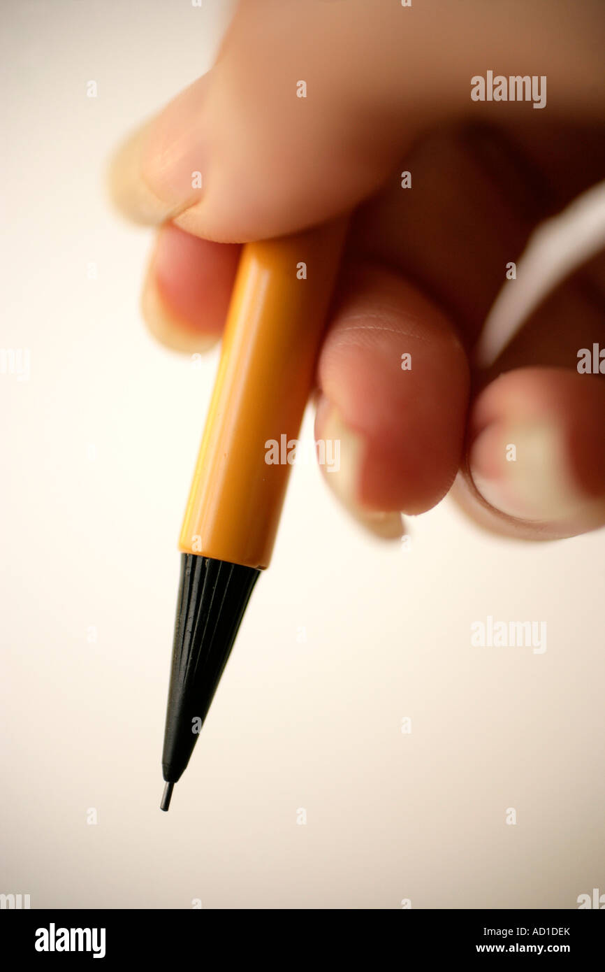 Hand holding pencil Stock Photo - Alamy