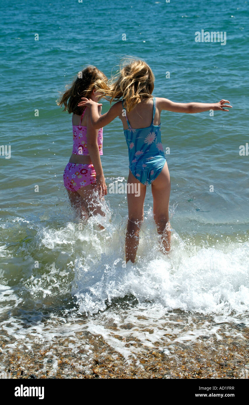 Little girls playing in the sea at seaside Southsea southern England UK ...