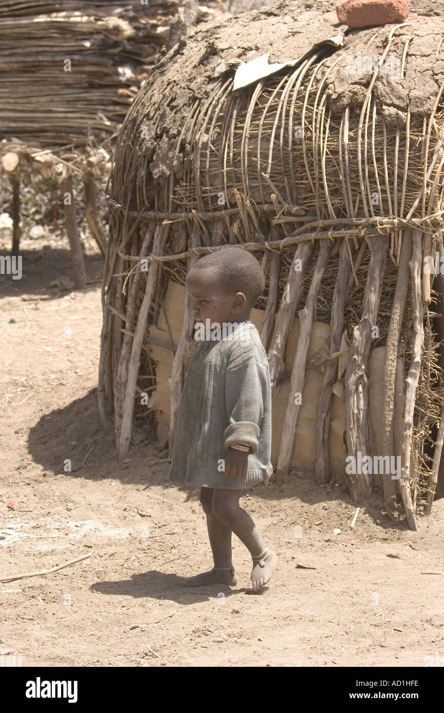Africa Tanzania people native tribe Masai child by mud home hut house ...