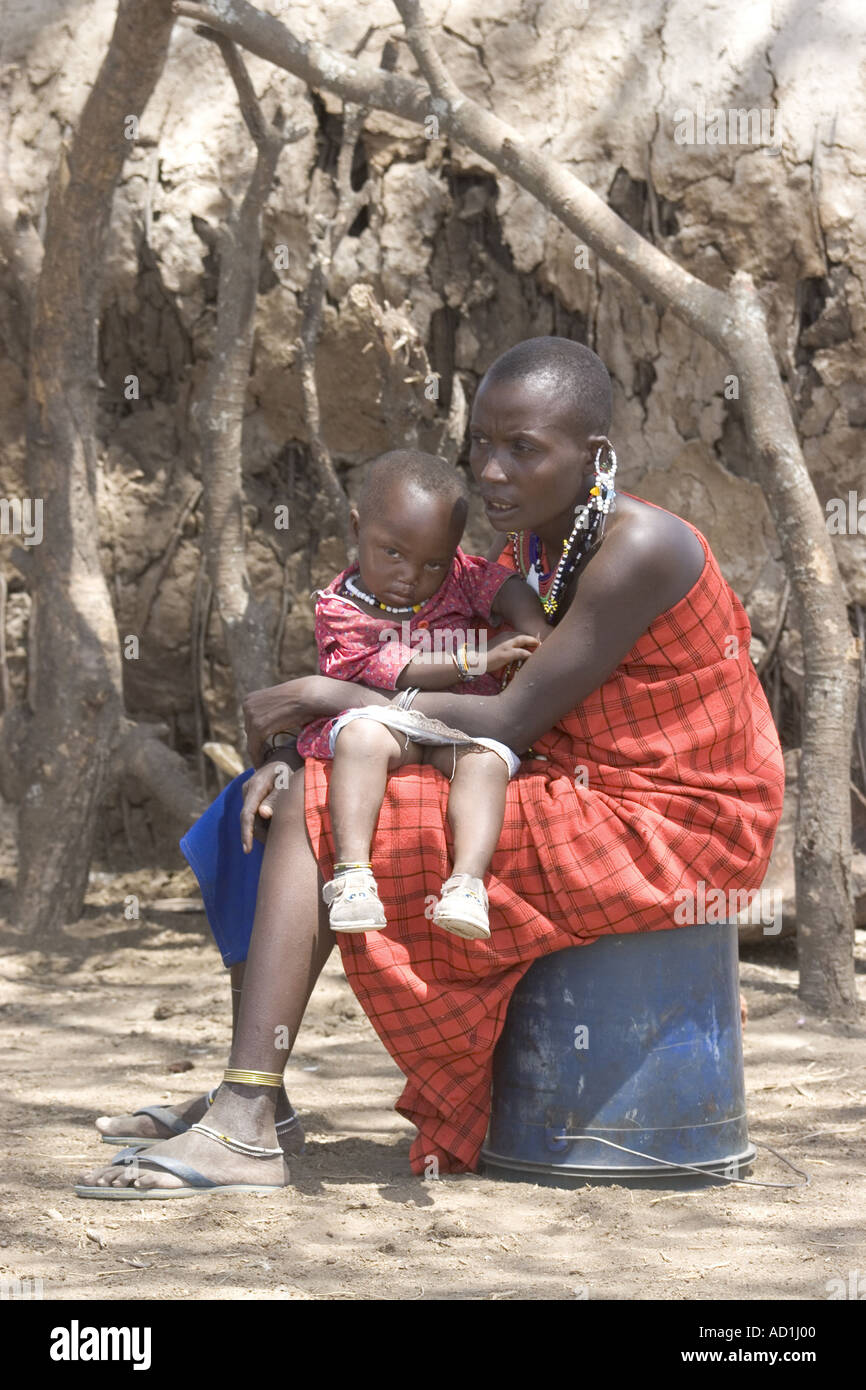 Africa Tanzania people native tribe Masai mother with child by mud home ...