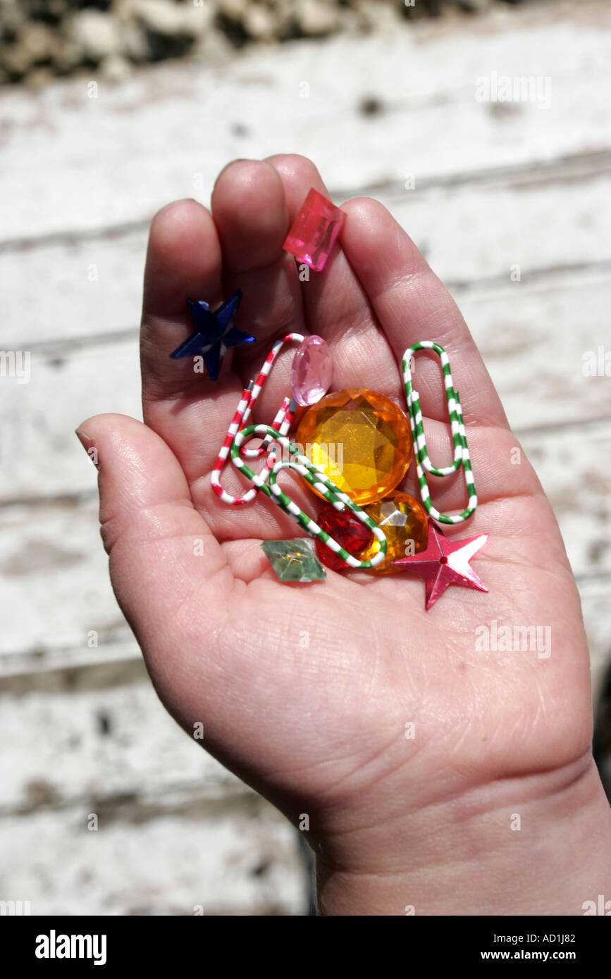 Child's hand holding gemstone treasures Stock Photo - Alamy