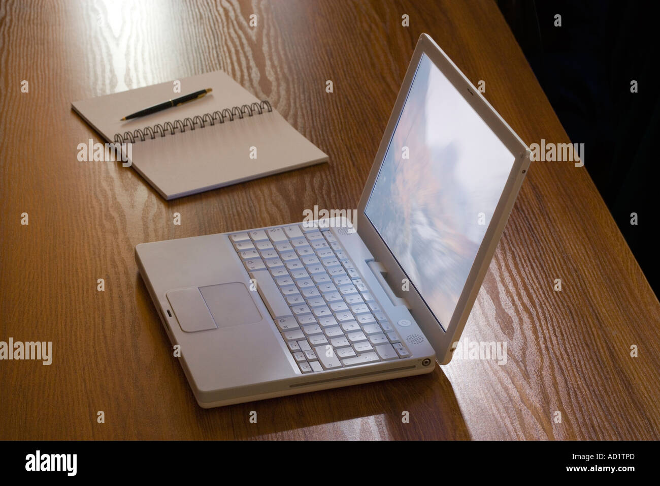 Laptop and notebook on desk Stock Photo - Alamy