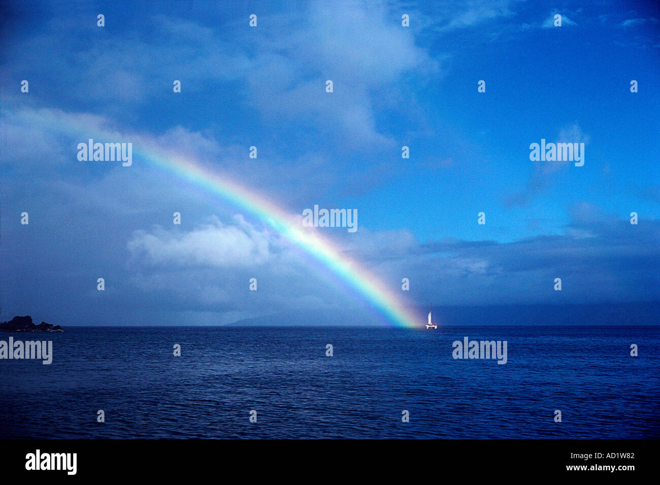Natural Rainbow setting on sailboat sailing between the Islands of ...