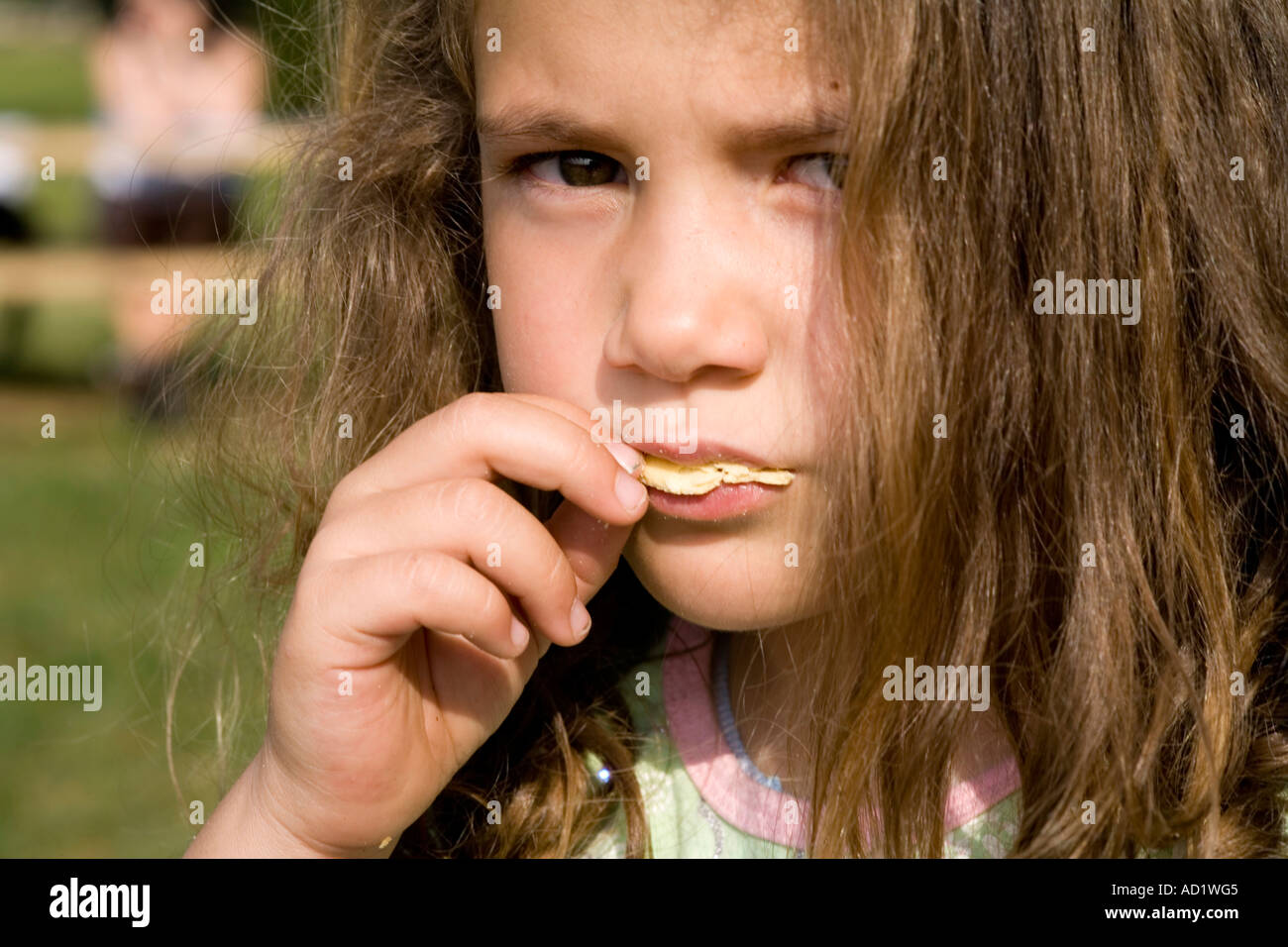 little girl having a cracker as a snack Stock Photo - Alamy