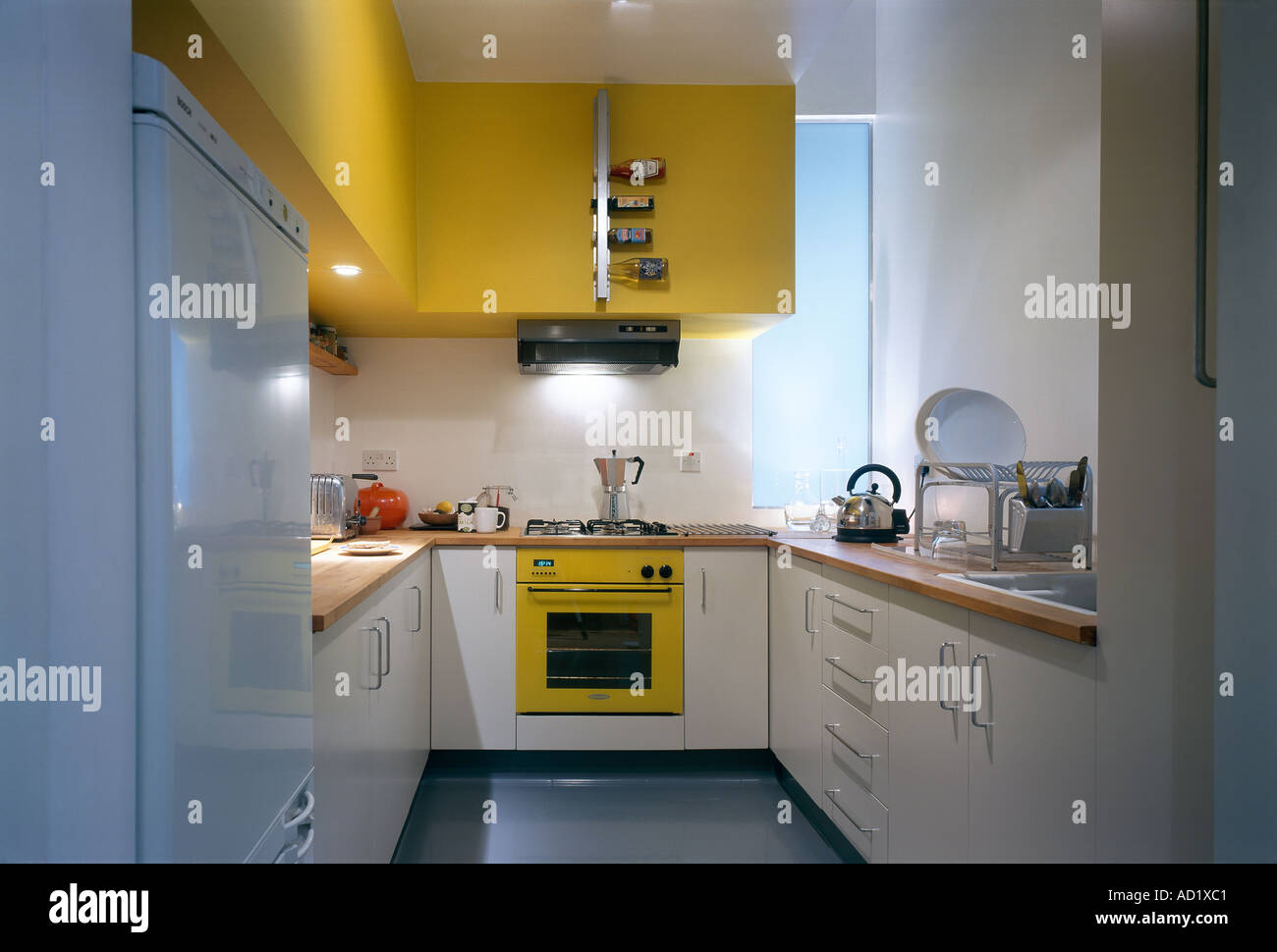 Glasgow Loft, Scotland. Kitchen with yellow cooker, yellow wall and ...
