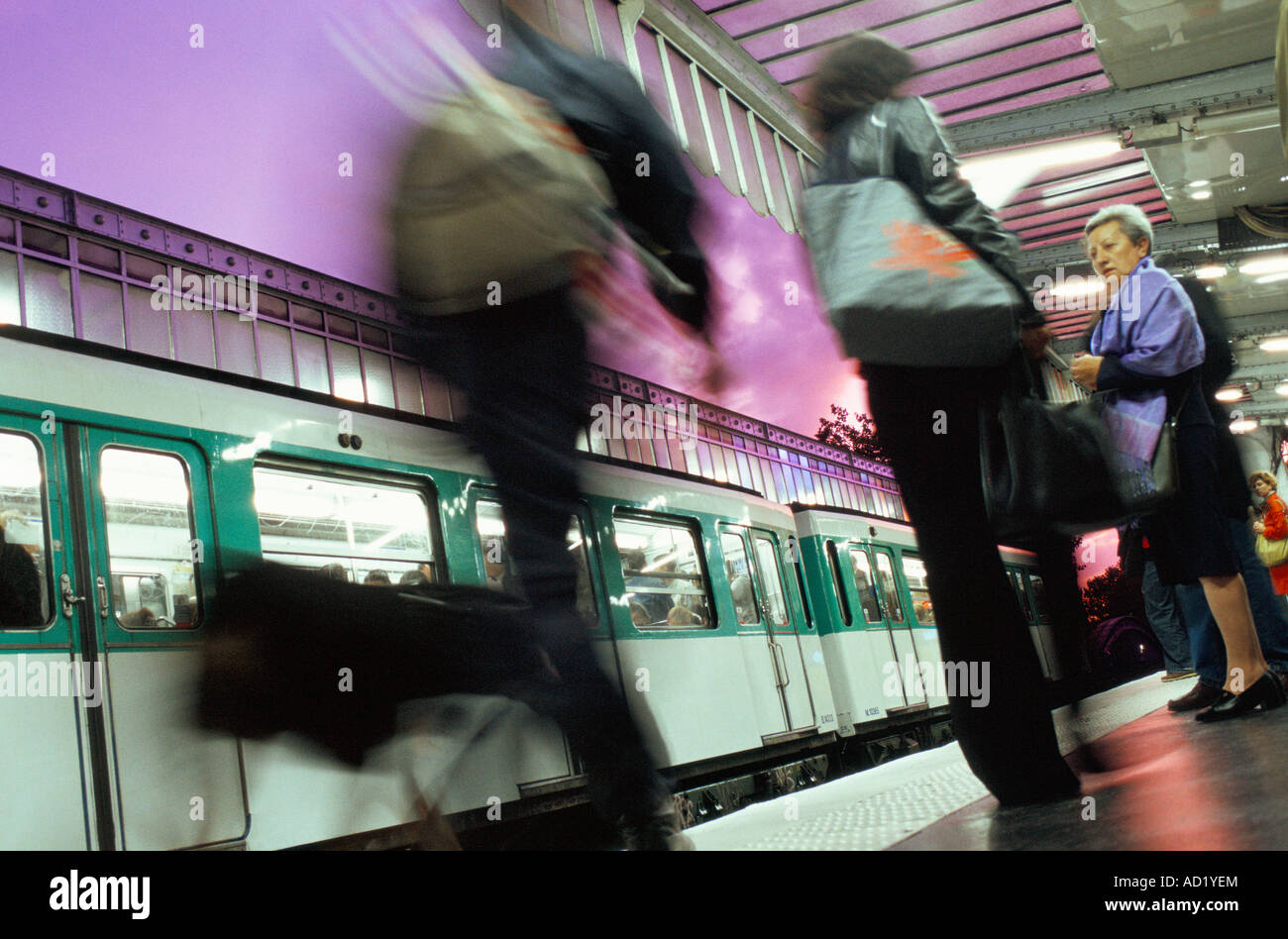 People waiting and getting on trains at the Metro Station at Barbes ...
